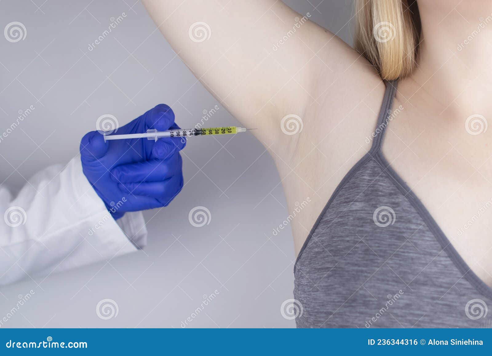 Woman Receiving Botulinum Toxin Injection In Armpit As Treatment Of