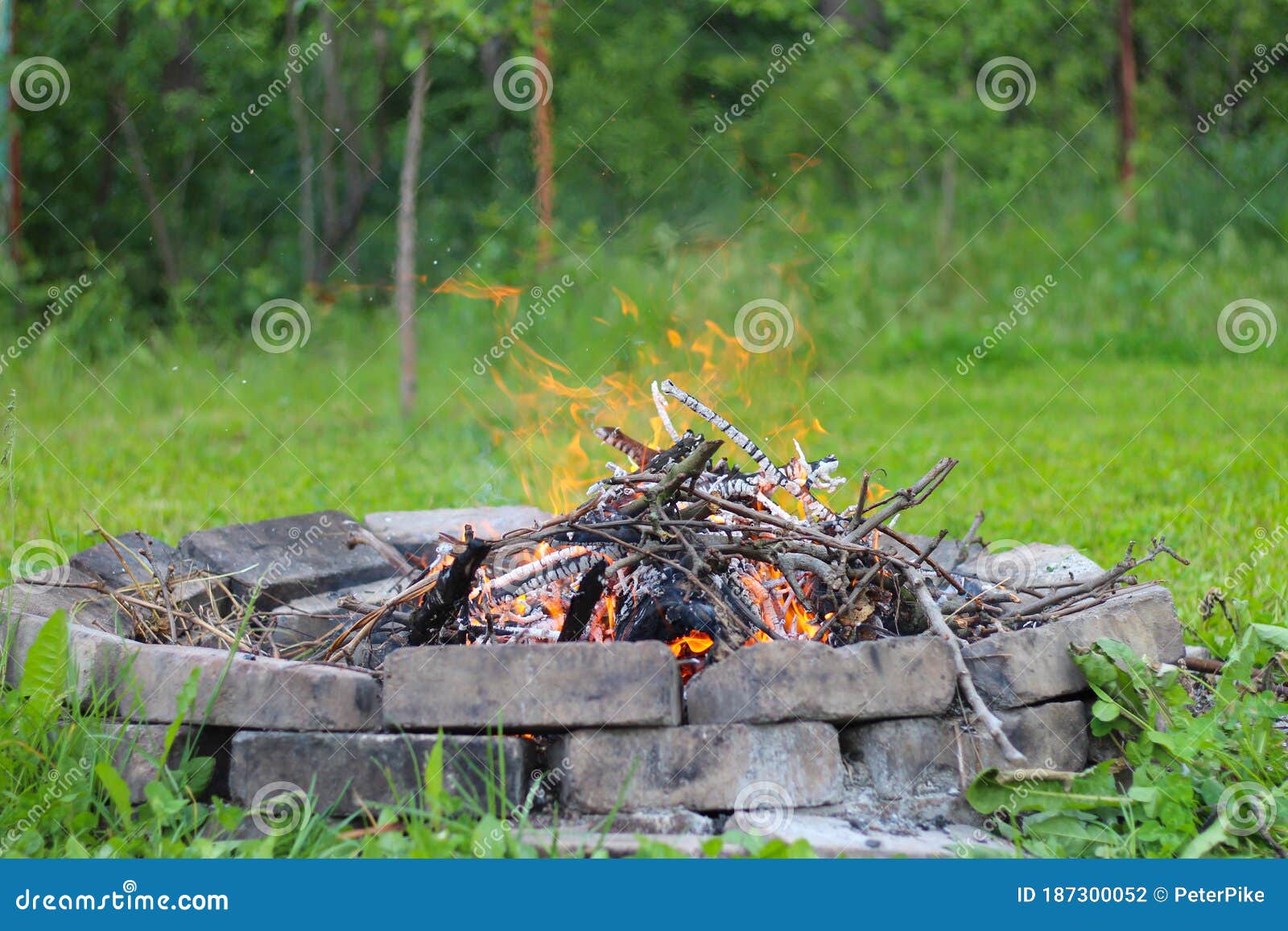 Tree Branches Burn in a Bonfire in a Round Brick Fireplace Stock Photo ...