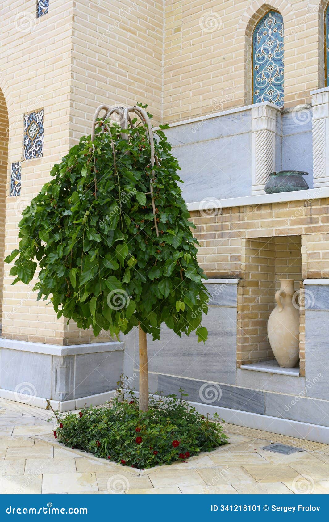 Tree and Brick Wall in a Traditional Asian Style with Mosaics and ...