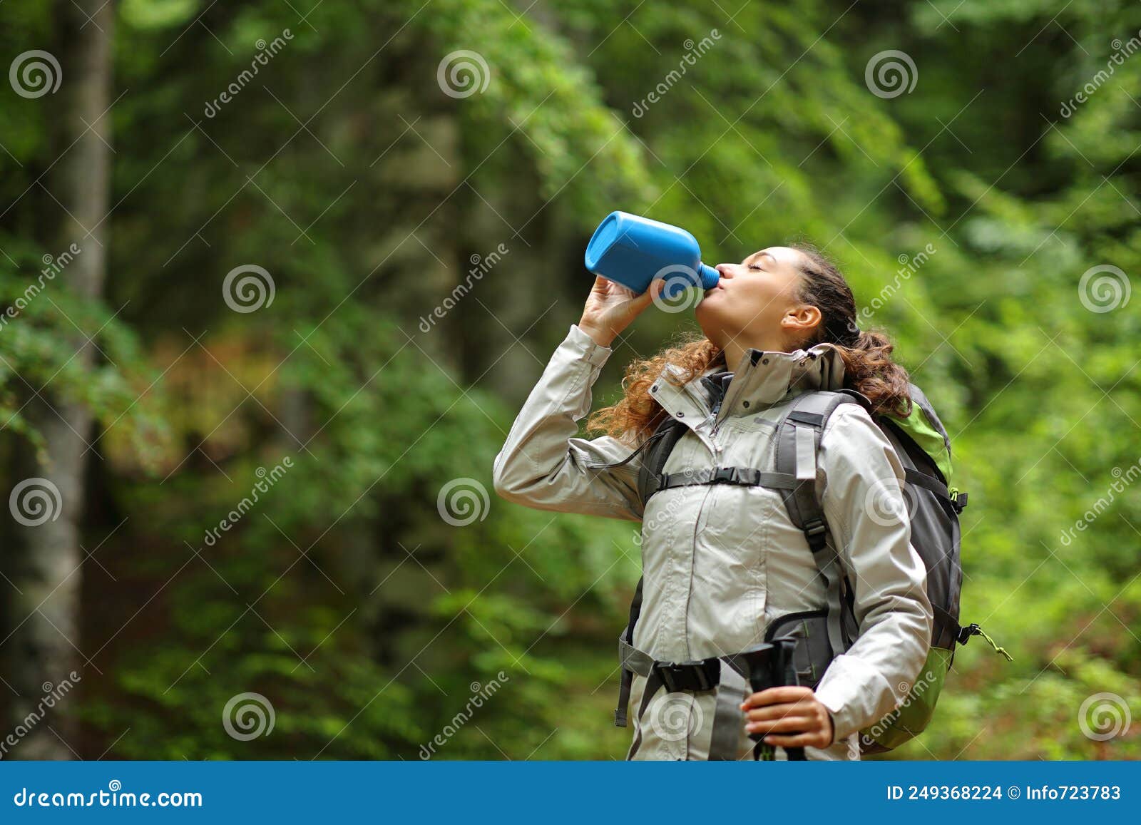 Trekker Drinking Water from Canteen in a Forest Stock Photo - Image of ...