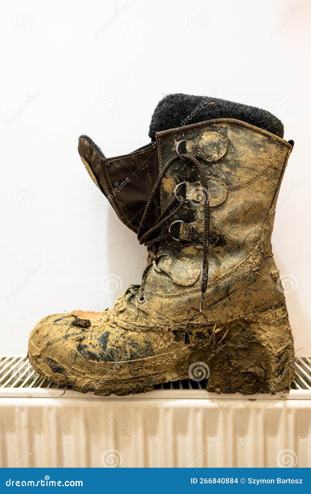 Trekking Boots Dirty in the Mud Drying on the Radiator Stock Photo ...