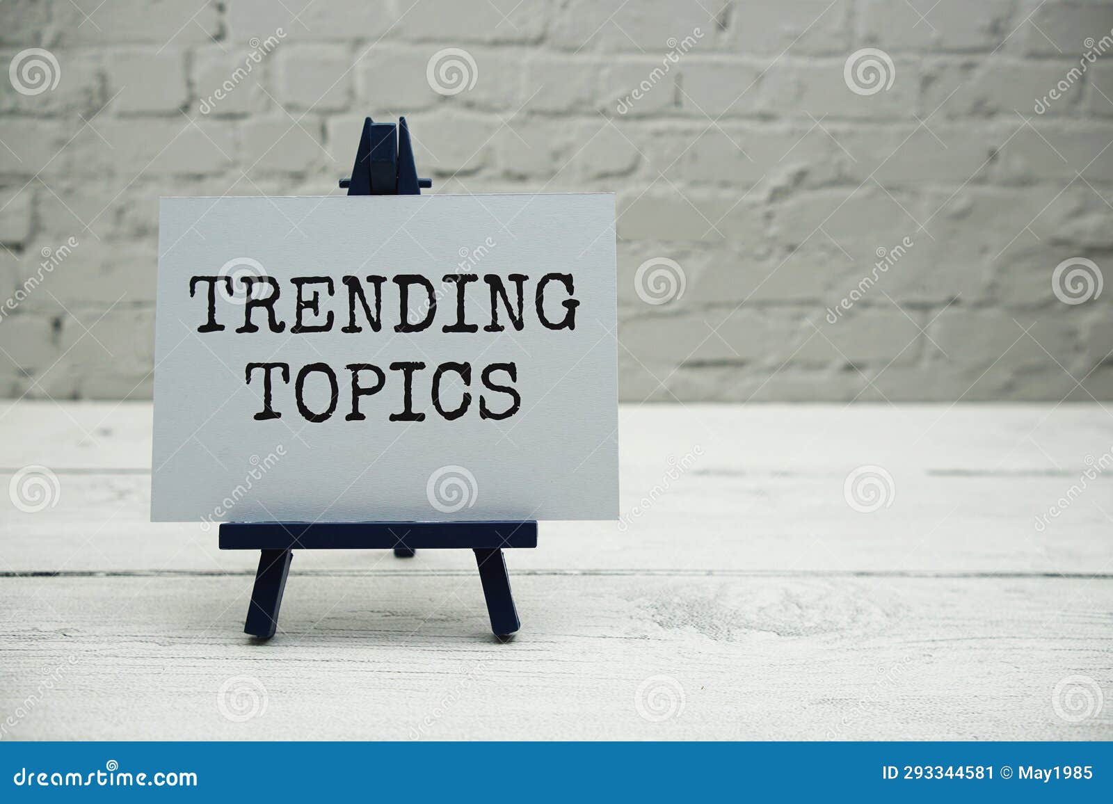 Trending Topics Text on White Brick Wall and Wooden Background Stock ...
