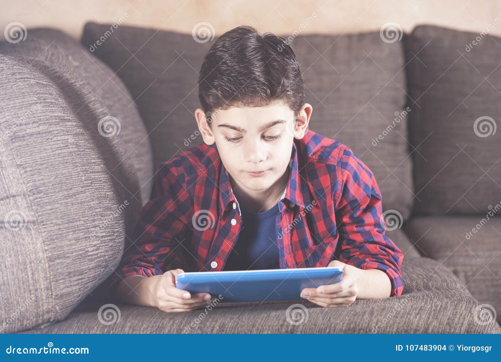 Trendy Boy Using His Tablet Stock Photo - Image of sofa, people: 107483904