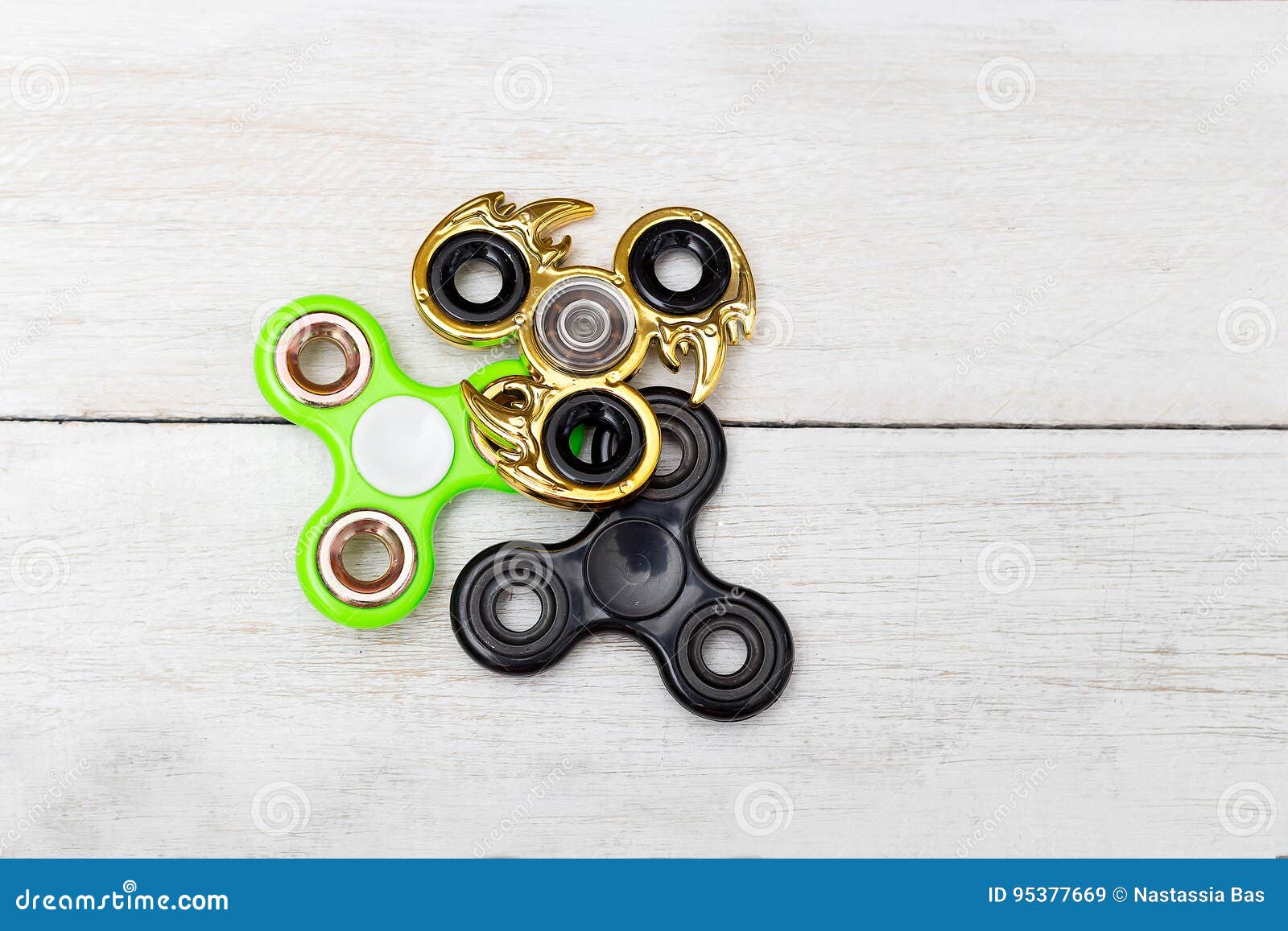 Trendy Fidget Spinners on White Wooden Background Stock Image - Image ...