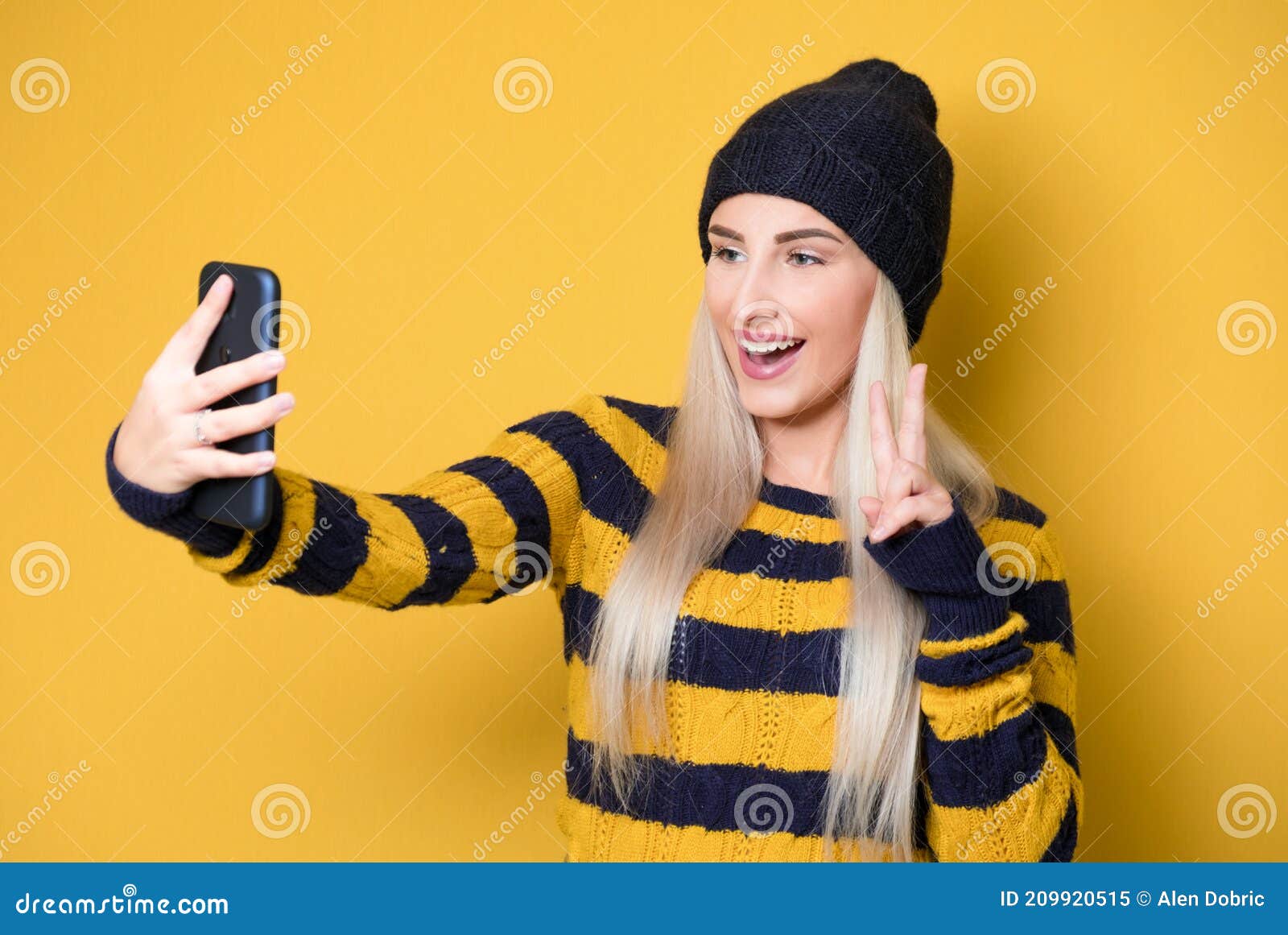 Trendy Girl Holding In Hands Smartphone And Making Selfie While Showing