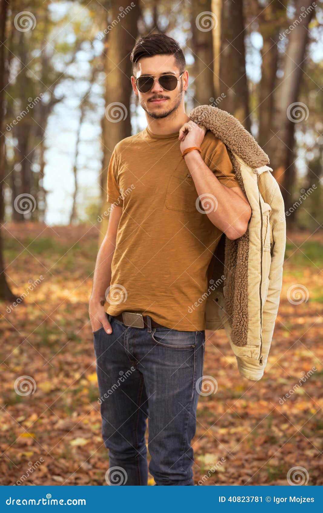 Trendy men posing in park stock image. Image of leaves - 40823781
