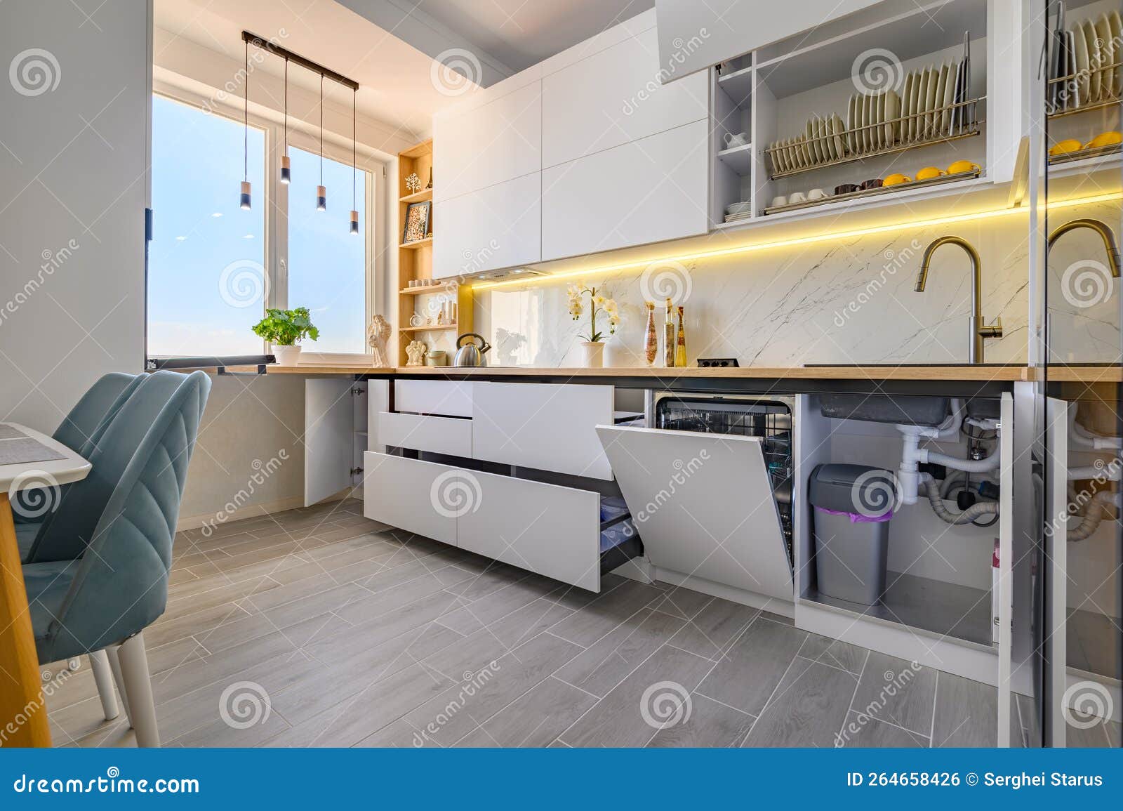 A Trendy White Kitchen with Drawers Pulled Out To Their Full Length ...