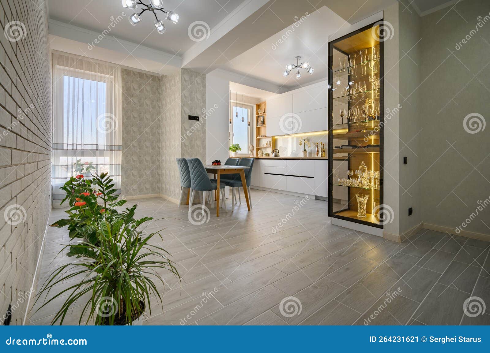 A Trendy White Studio Apartment with a Kitchen that is Fully Stocked ...