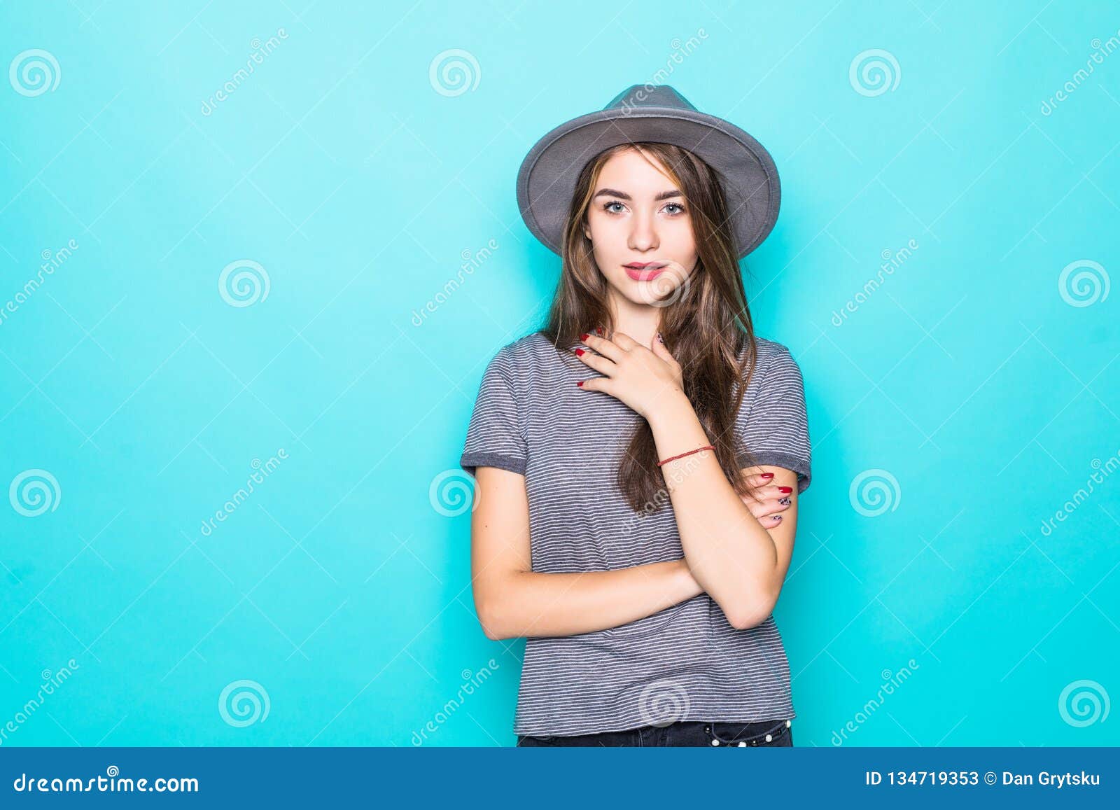 Trendy Young Woman Wearing Casual Clothes Posing Over Green Background