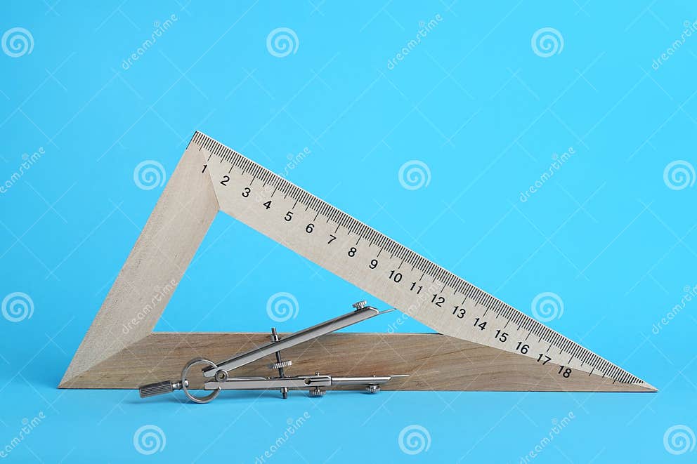 Triangle Ruler and Compass on Light Blue Background Stock Image - Image ...