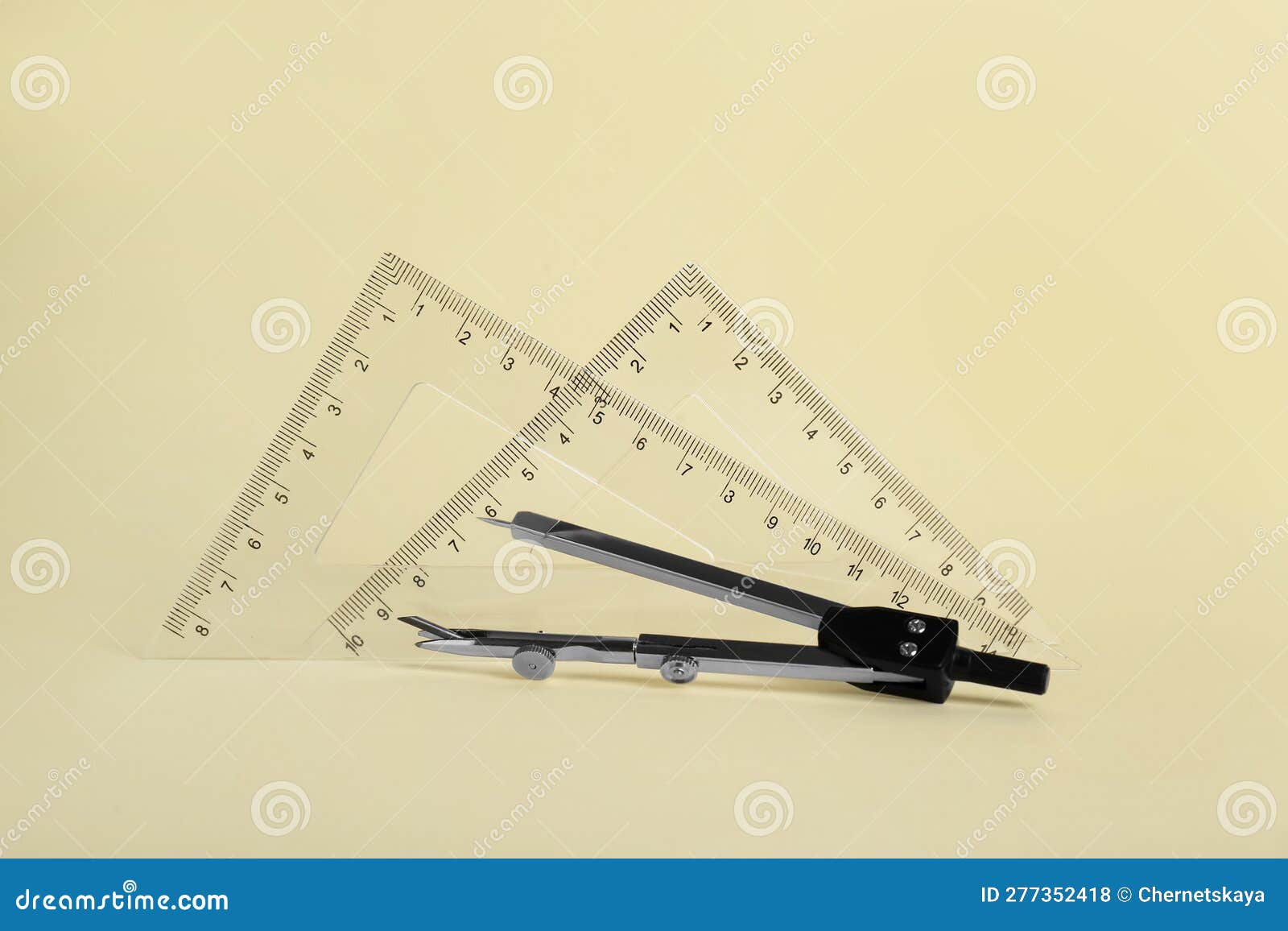 Triangle Rulers and Compass on Light Yellow Background Stock Photo ...