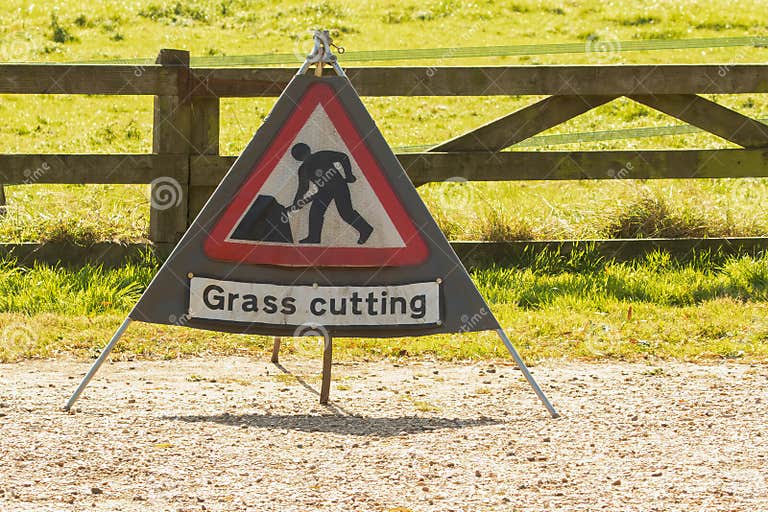 Triangle Warning Sign with Warning Saying Grass Cutting with Copy Space ...