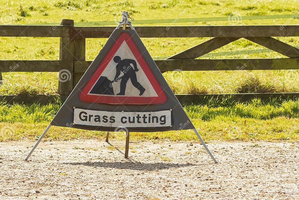 Triangle Warning Sign with Warning Saying Grass Cutting with Copy Space ...