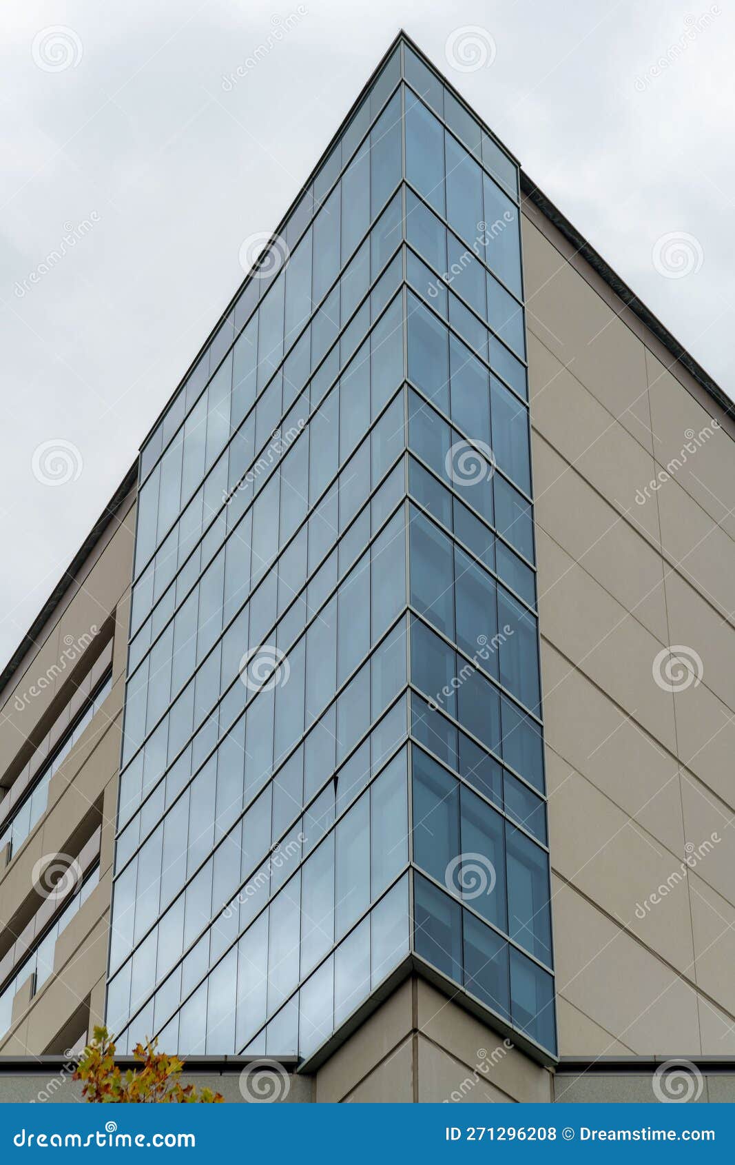 Triangular Building with Sleek Glass Windows and Cement or Stucco ...