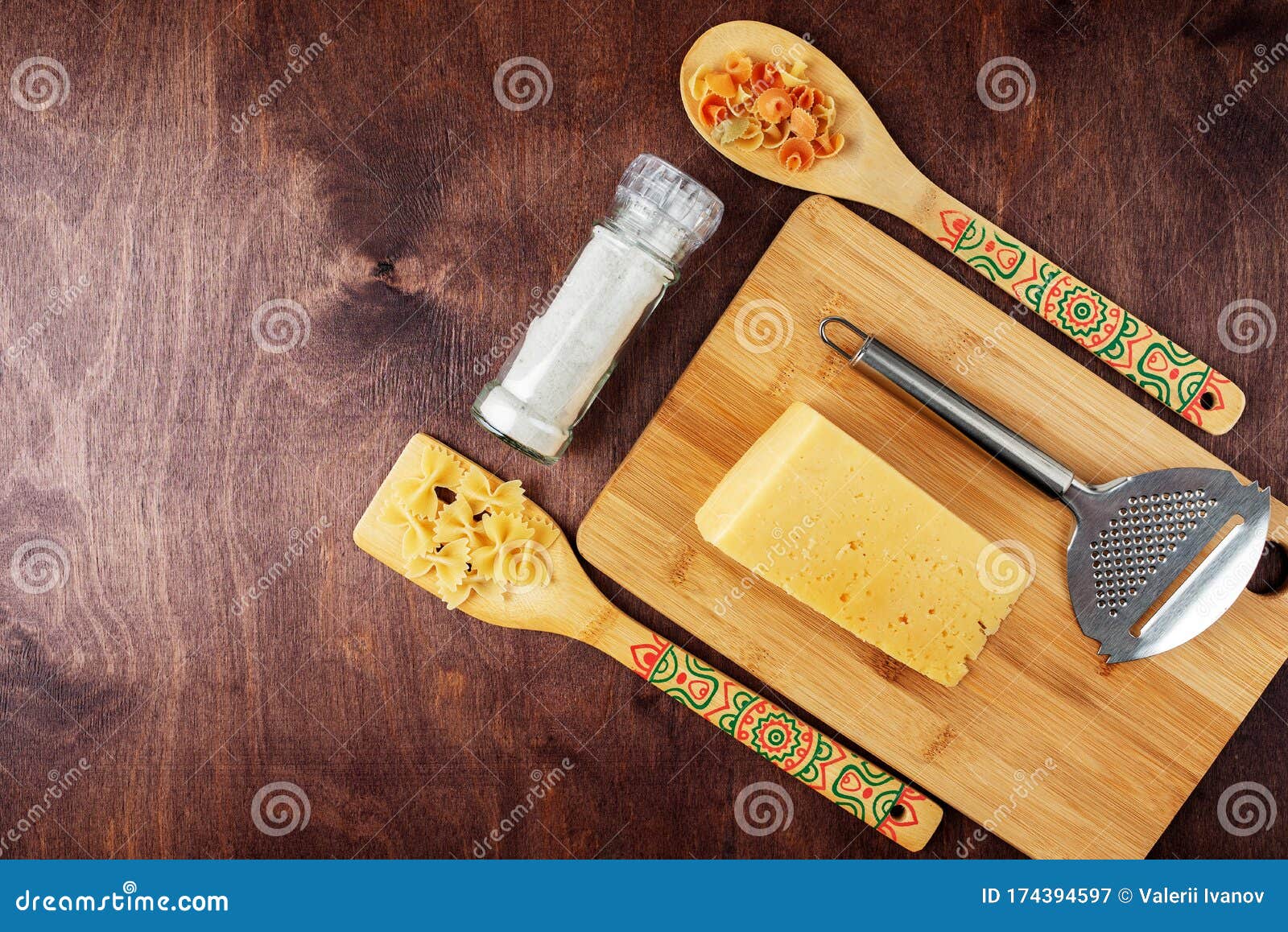 Triangular Cheese and Grater on a Cutting Board. Bamboo Spatulas with ...