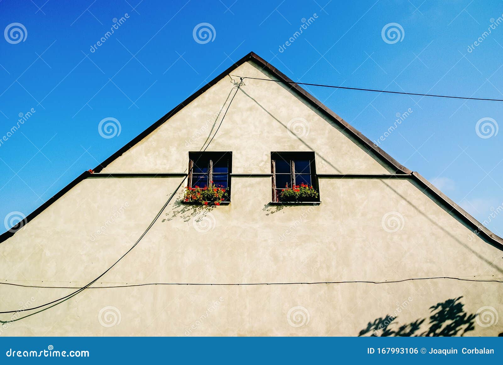 Triangular Facade of a Rural House with Two Square Symmetrical Windows ...