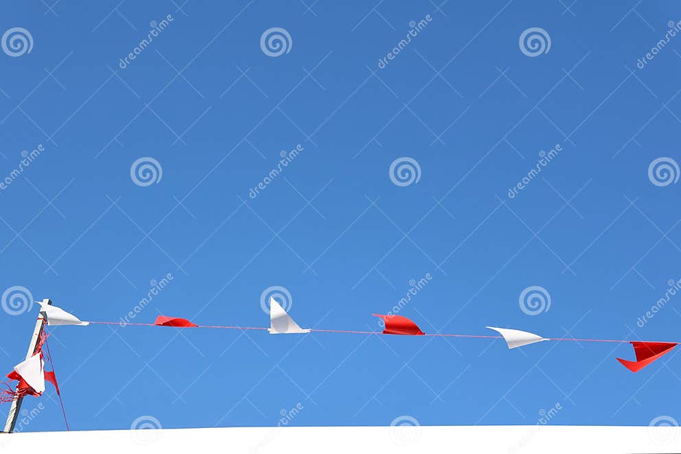 Triangular Flag, Red and White, when the Wind Blows on Blue Sky Stock ...