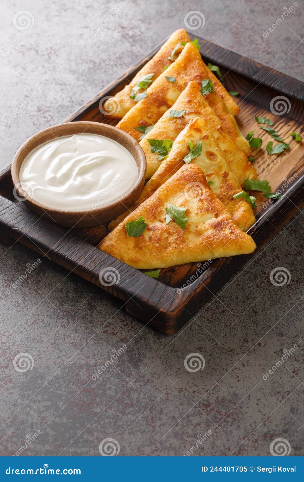 Triangular Fried Pancakes with Meat Served with Sour Cream Close Up on ...