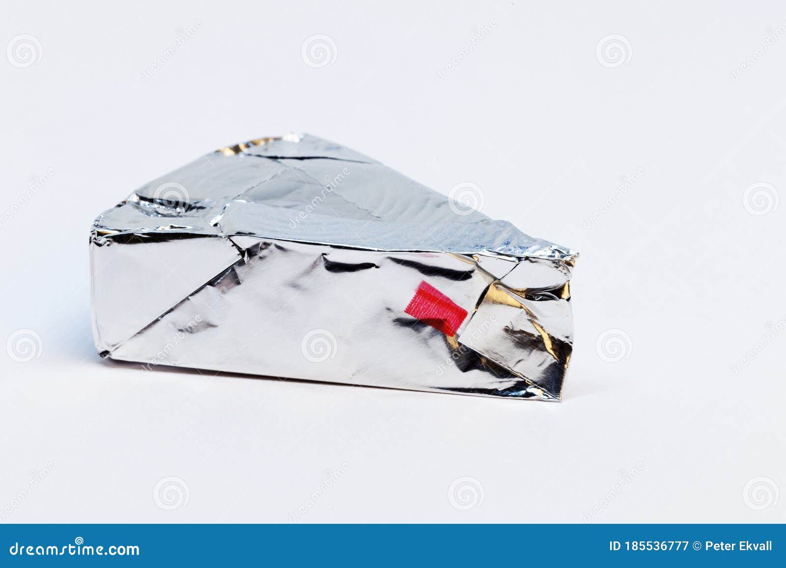 Triangular Piece of Cheese Wrapped in Silver Foil Stock Image - Image ...