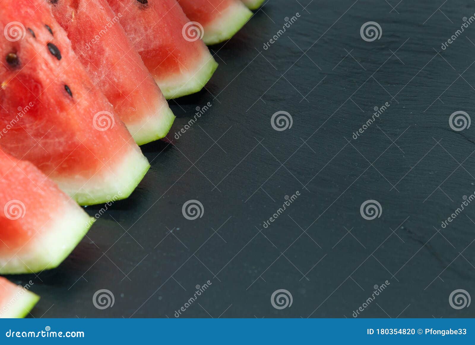Triangular Pieces of Water Melon Arranged on Black in Line with Copy ...