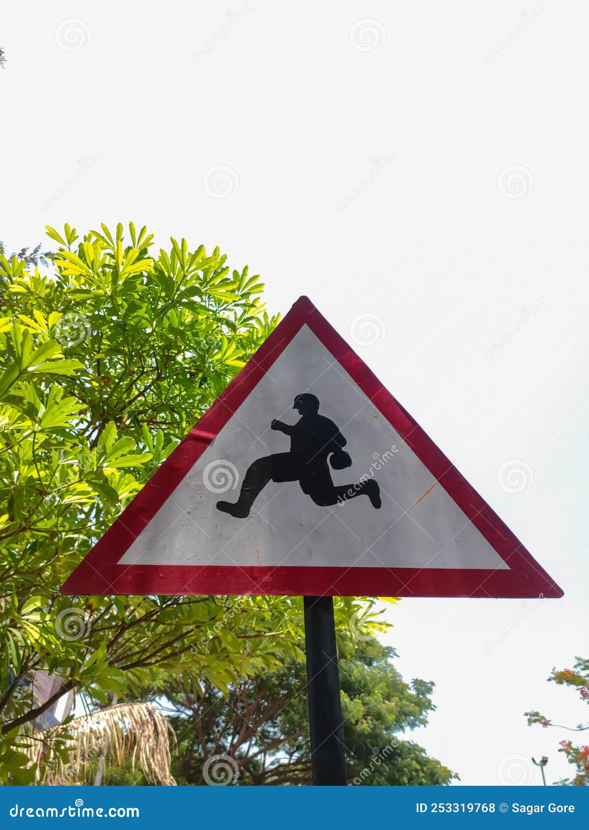 A Triangular Red and White Warning Sign Depicting Running Children ...