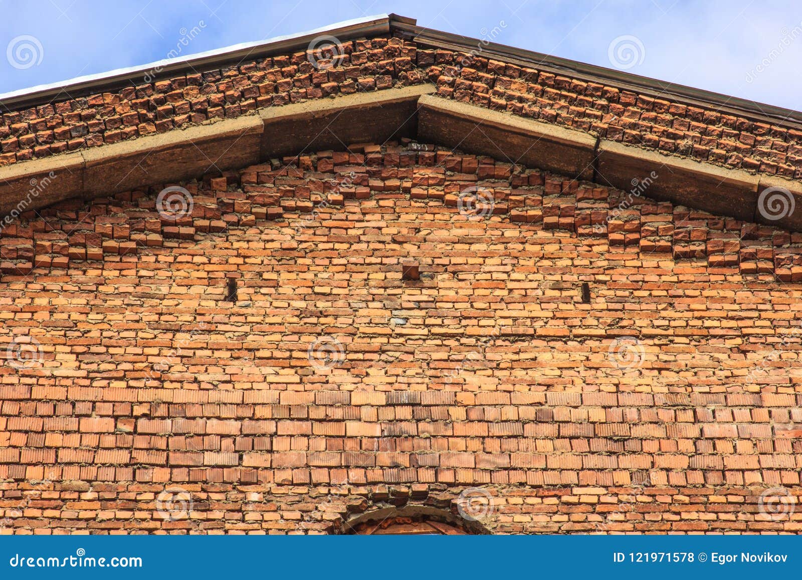 Triangular Roof of an Old Building of Orange Bricks Against a Blue Sky ...