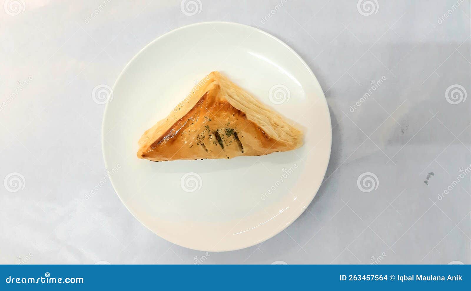 Triangular Shaped Puff Pastry Bread on a Clean White Plate Stock Photo ...