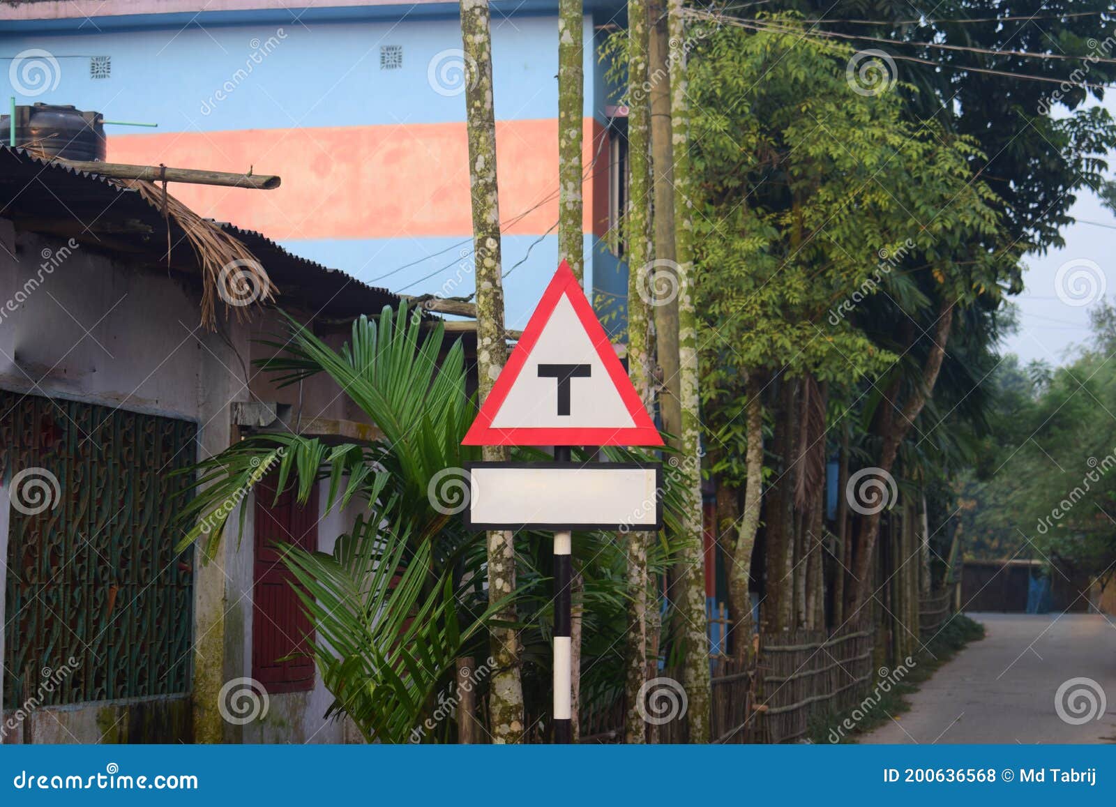 Triangular Shaped Road Sign beside a Road Stock Photo - Image of road ...
