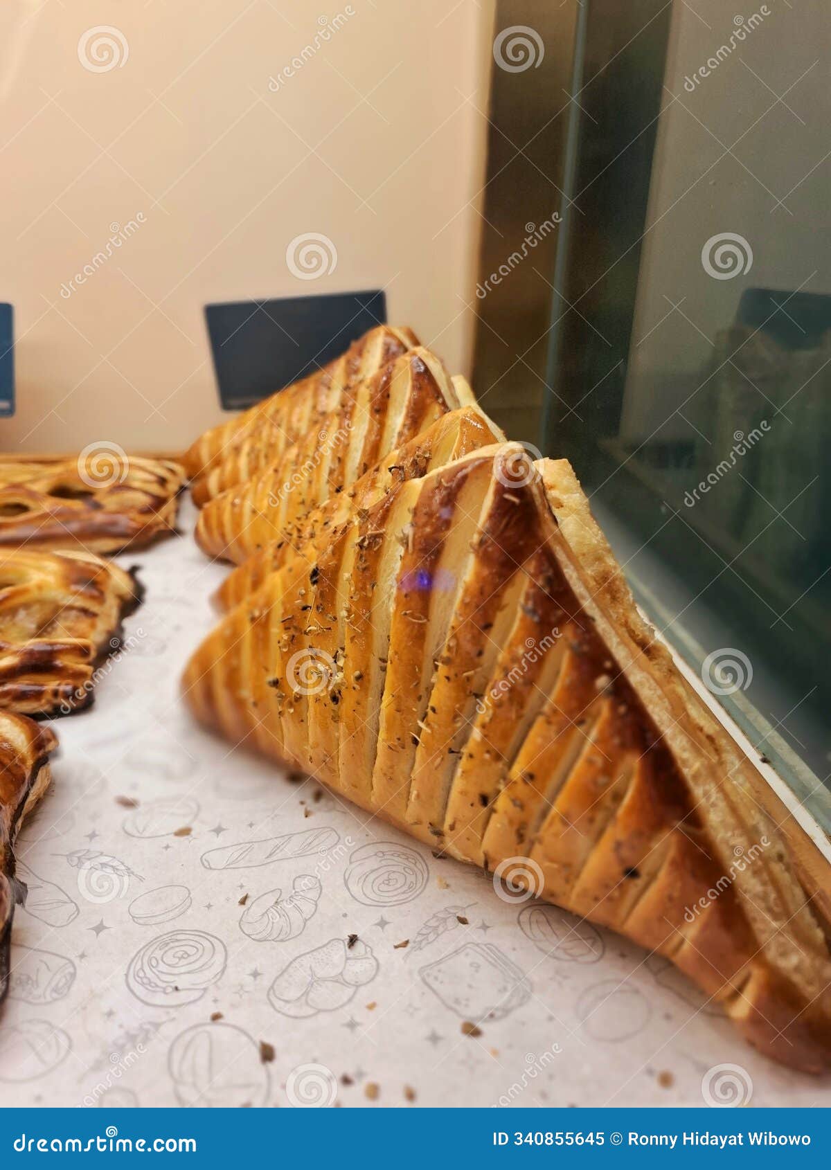 The Triangular-shaped Tuna Puff Cake Arranged in a Glass Display Case ...