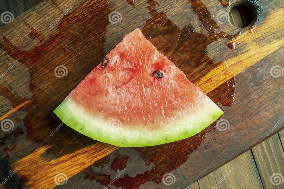 A Triangular Slice of Watermelon on a Wooden Table. Beautiful Slice of ...