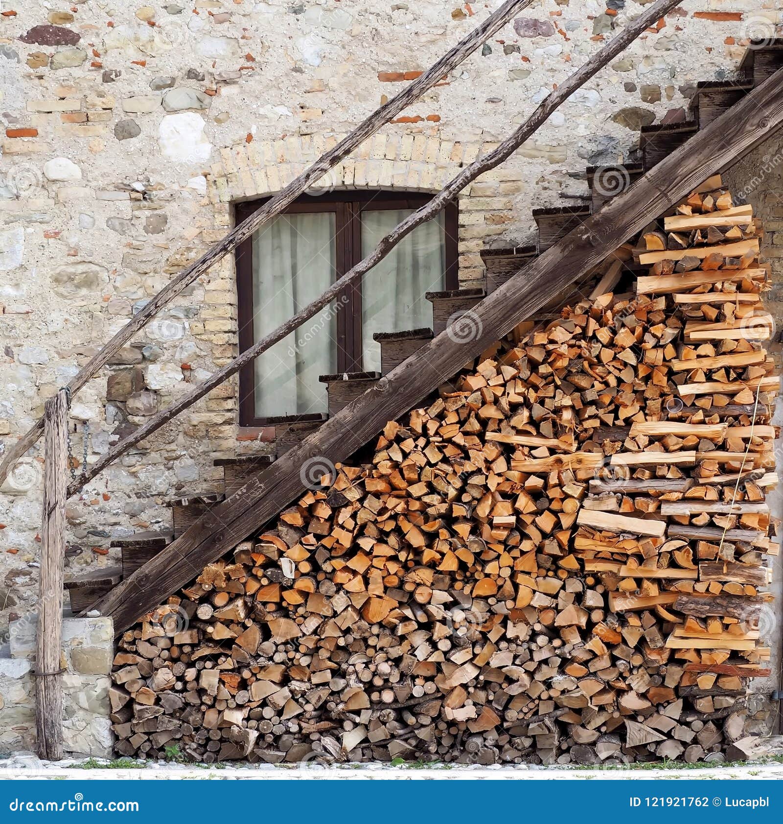 Triangular Stack Of Firewood Under A Wooden Stair In A Rustic Country ...