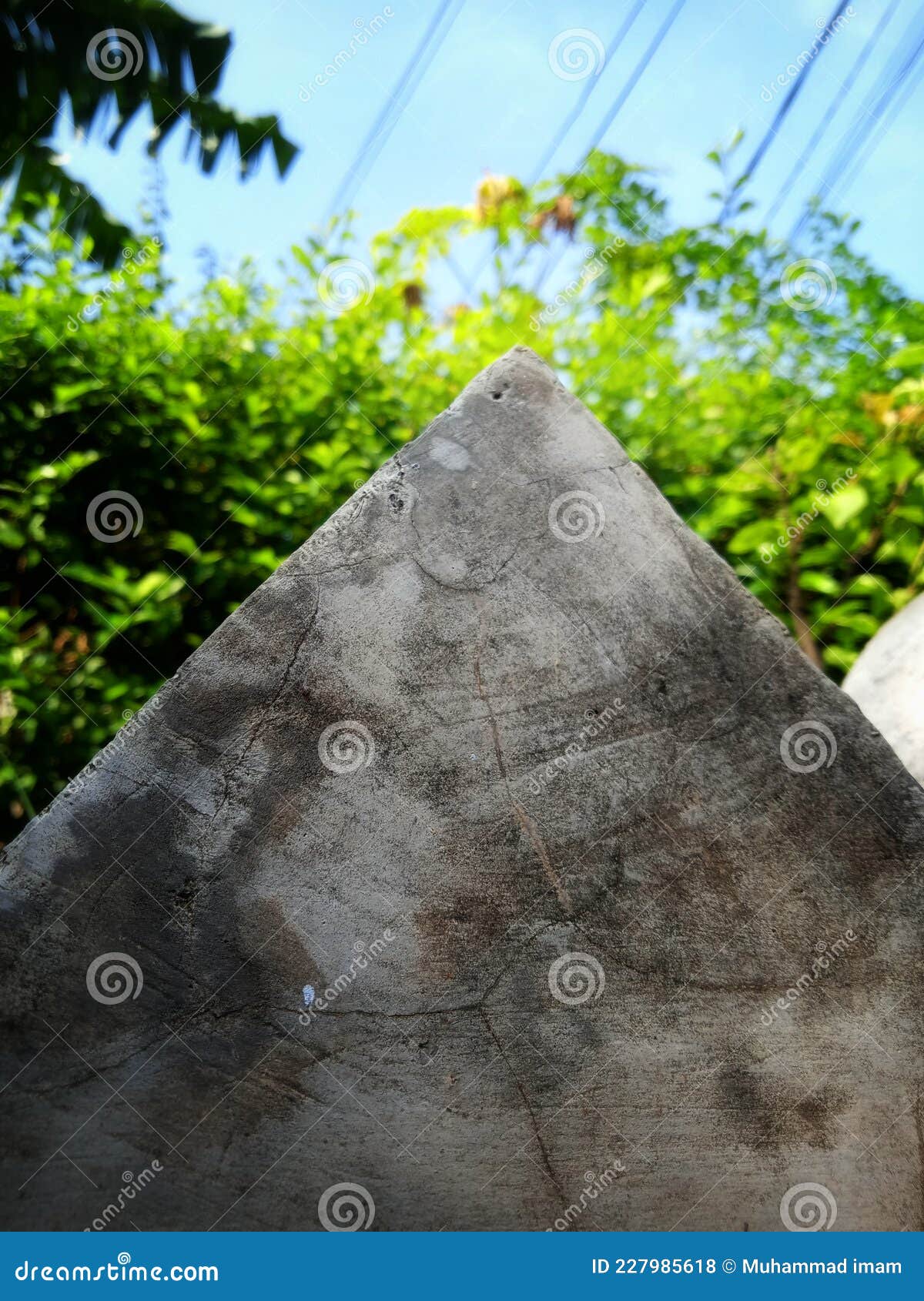 Triangular Stone with Trees in the Background Stock Photo - Image of ...