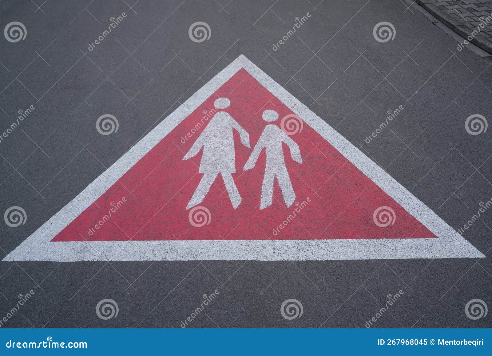 Triangular Warning Sign on the Paved Road Showing Walking Pedestrians ...