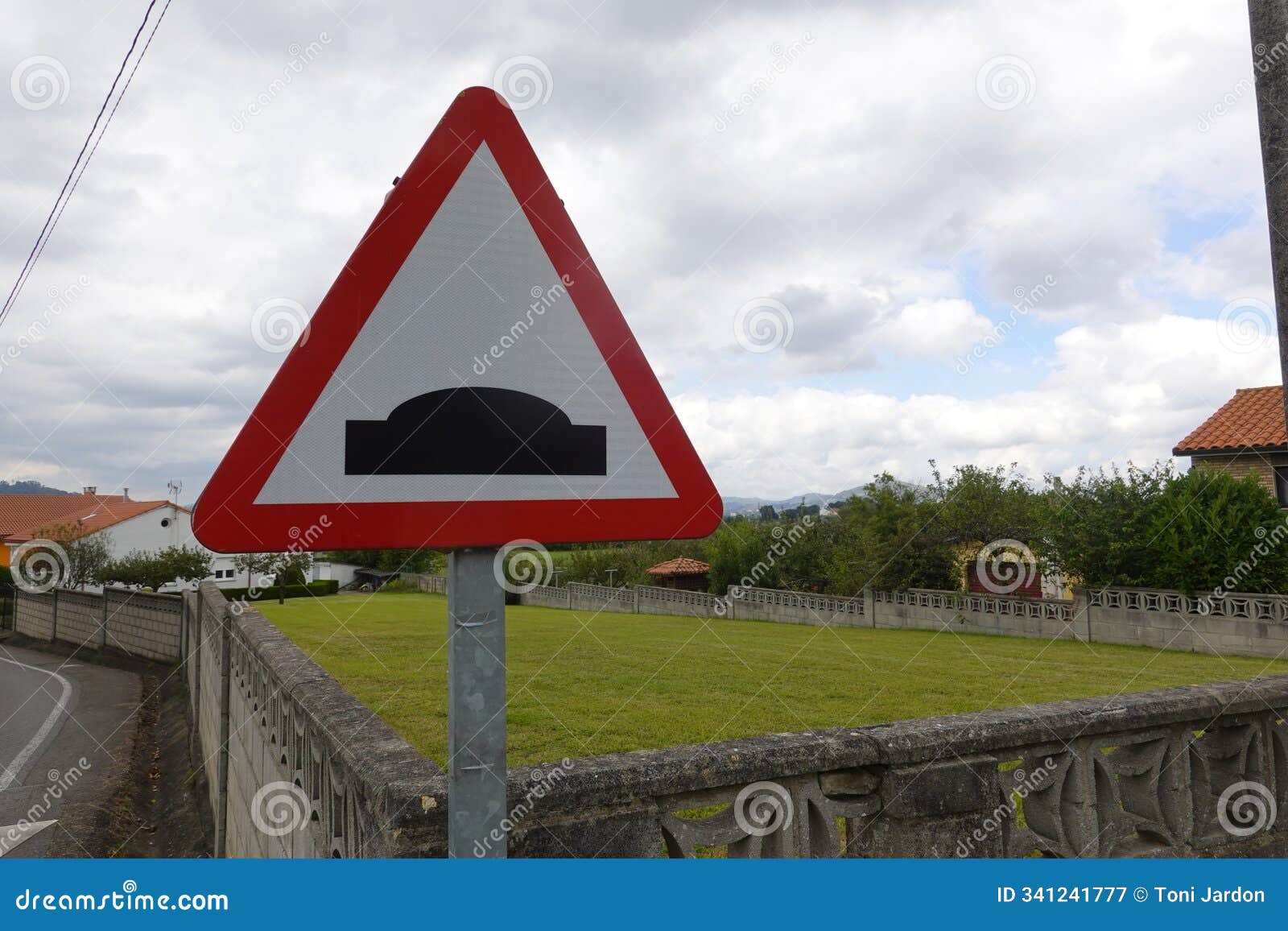 A Triangular Warning Sign for a Speed Bump is Positioned Near a ...