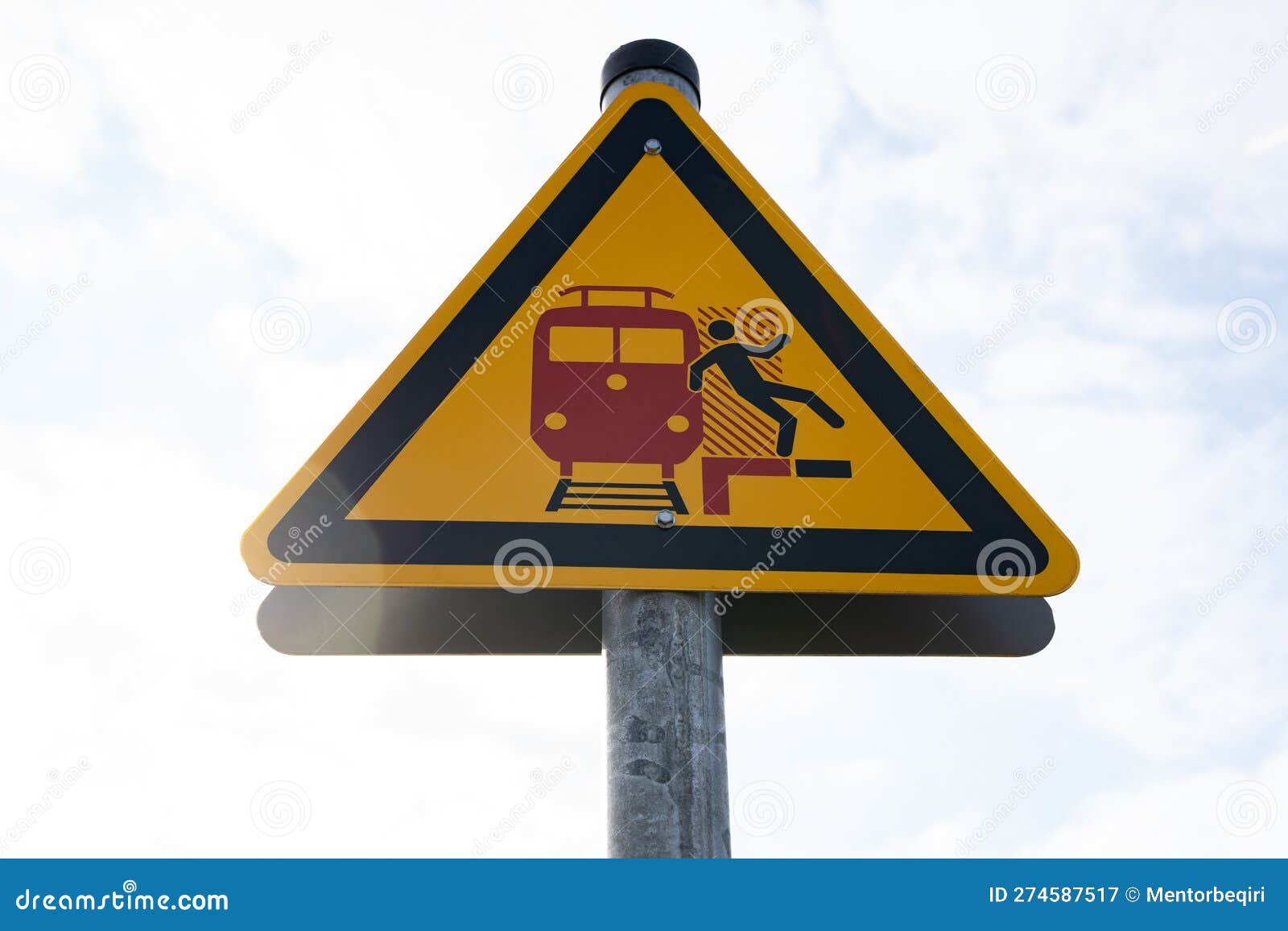 Triangular Yellow Warning Sign on the Platform Meaning Beware of ...