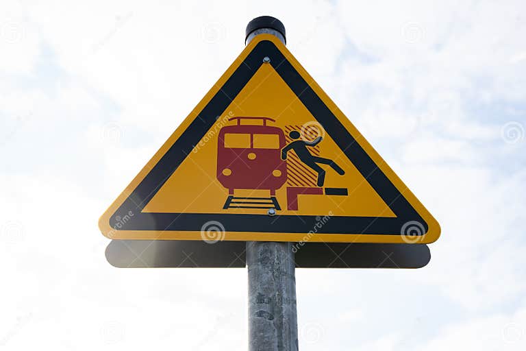 Triangular Yellow Warning Sign on the Platform Meaning Beware of ...