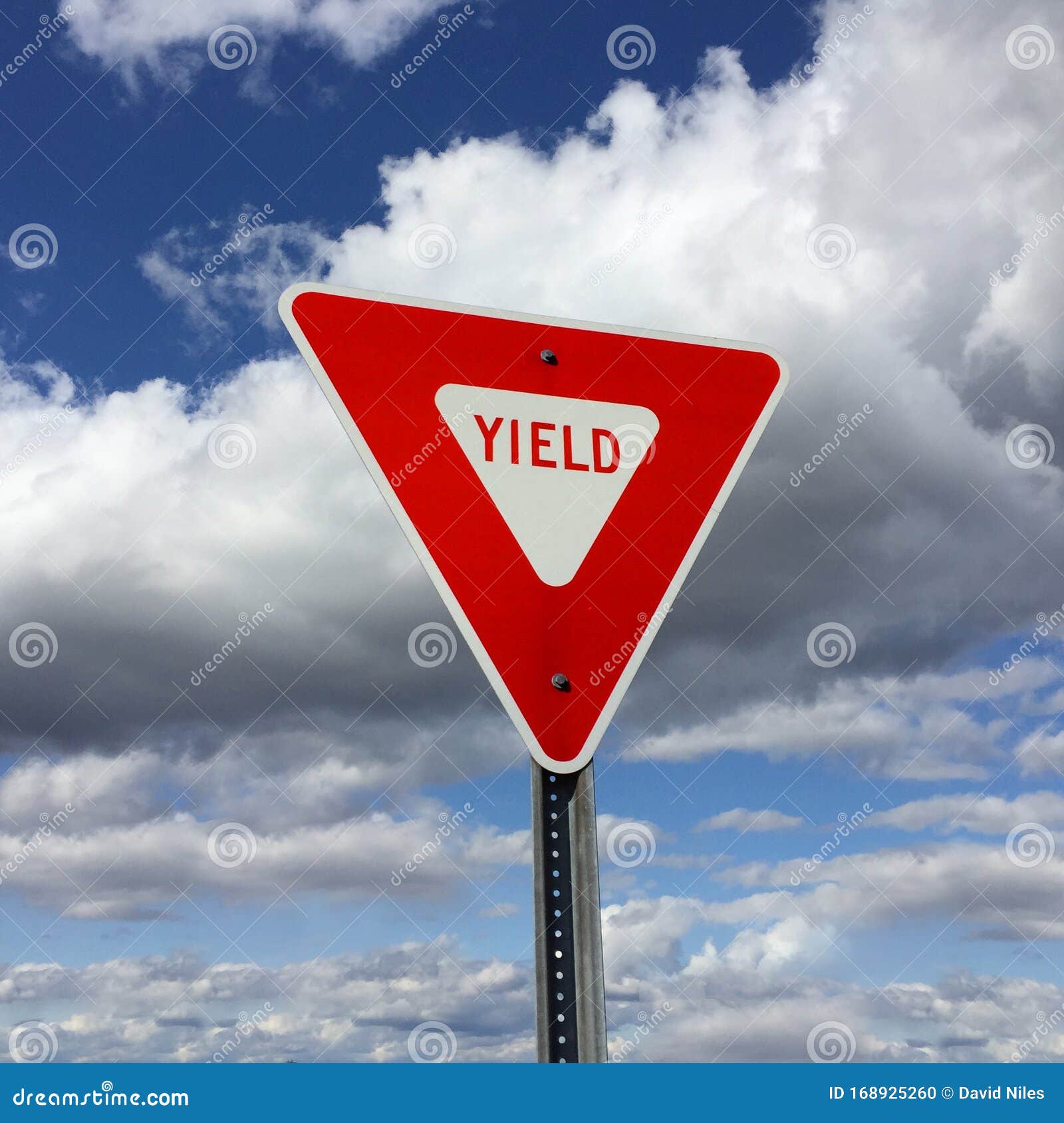Triangular Yield Sign Against a Blue Sky Stock Photo - Image of yield ...