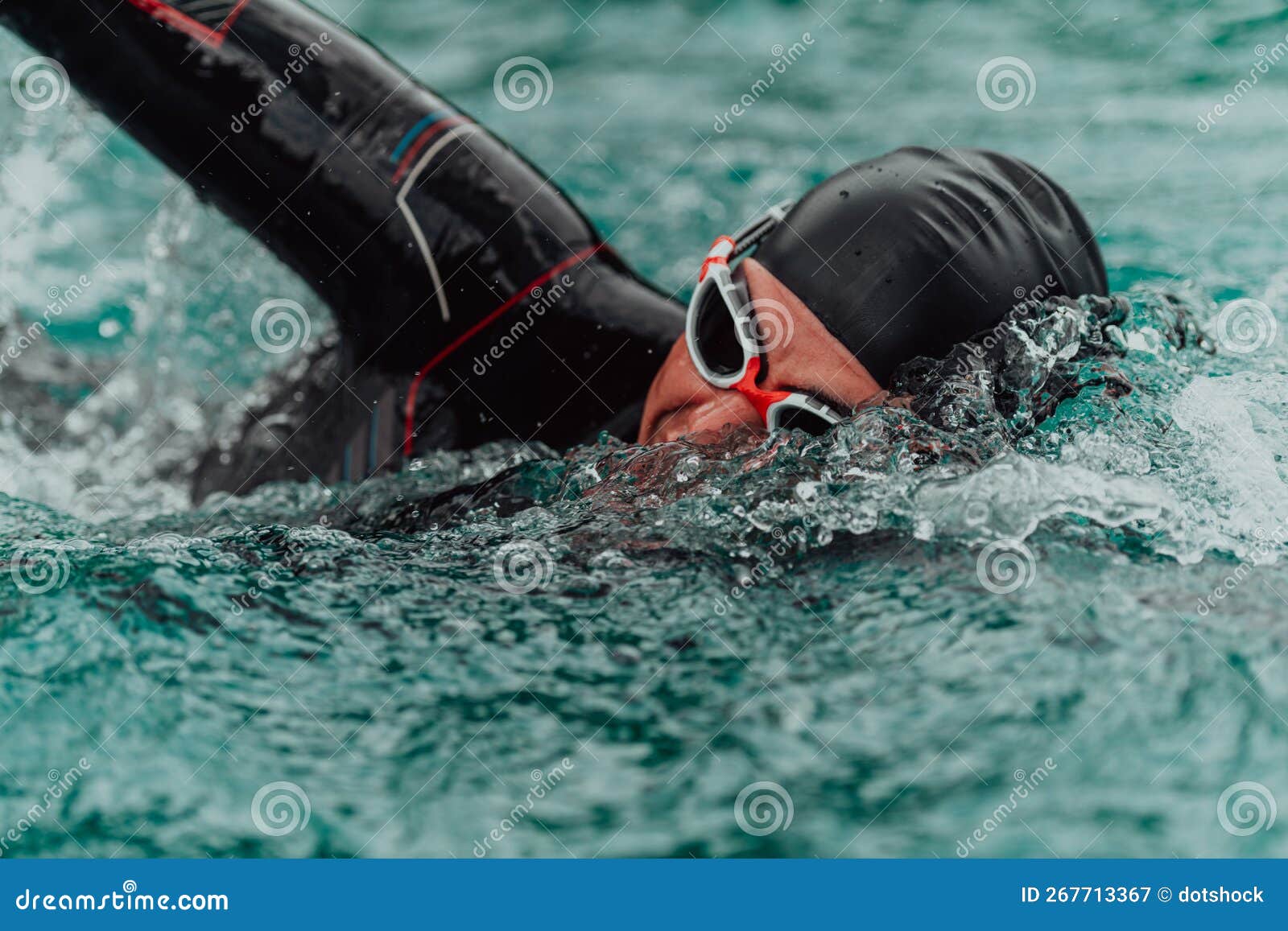 A Triathlete in a Professional Swimming Suit Trains on the River while ...