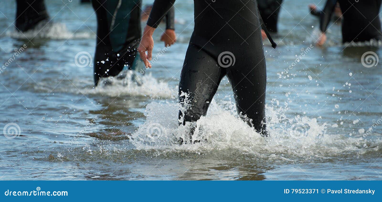 Triathletes running in sea stock image. Image of race - 79523371