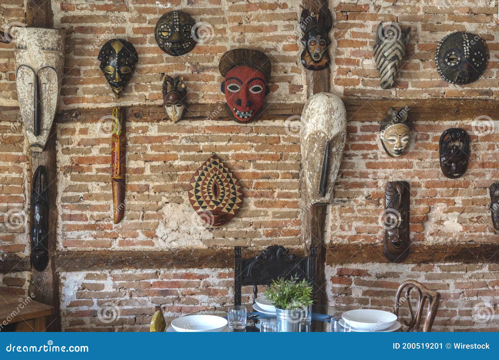 Tribal Masks Hung on a Brick Wall. Editorial Photo - Image of brick ...