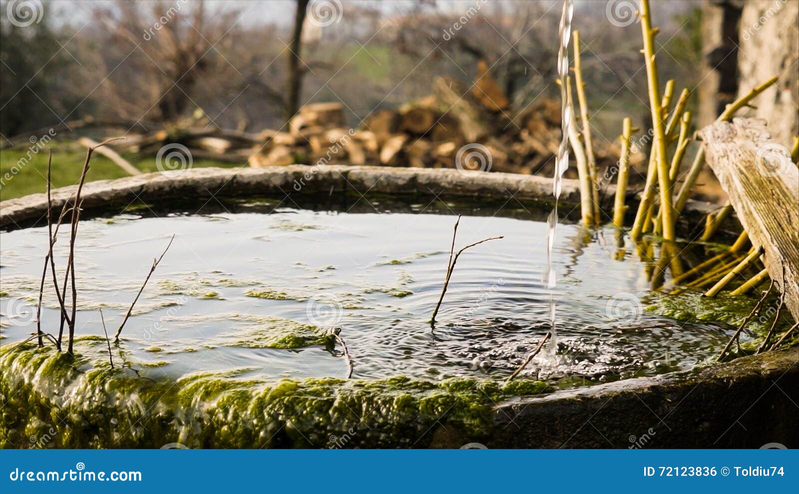 Trickle Of Water Flowing From Red Metal Drain Pipe On Cement On The ...