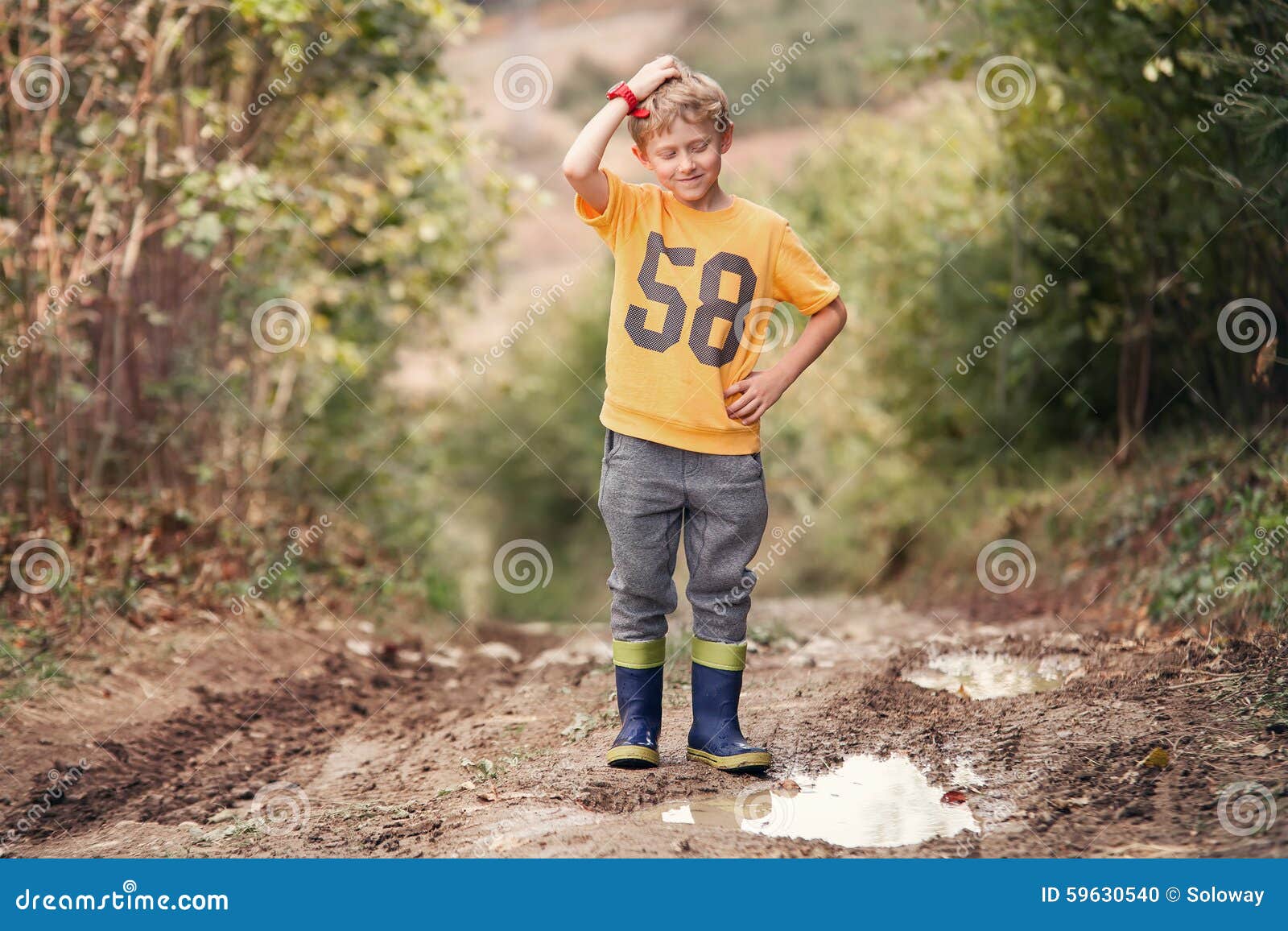 Tricky Face Boy Near the Puddle on Country Road Stock Photo - Image of ...
