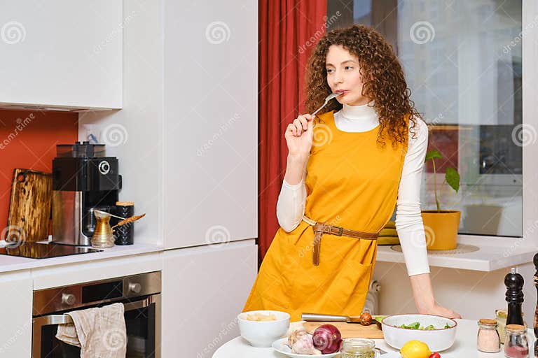 Tricky Woman Licks Spoon While Making Food In Kitchen Stock Image Image Of Cheerful Stand