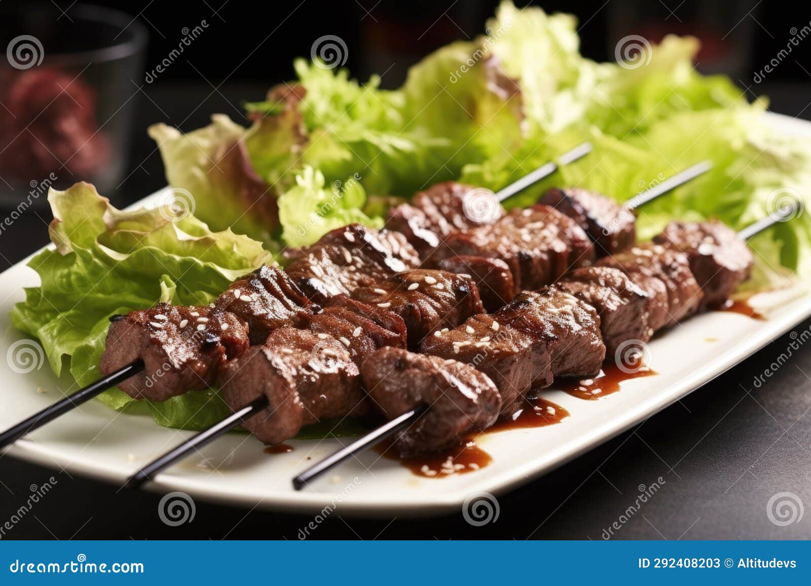 A Trio of Beef Skewers on a Bed of Mixed Lettuce Stock Image - Image of ...