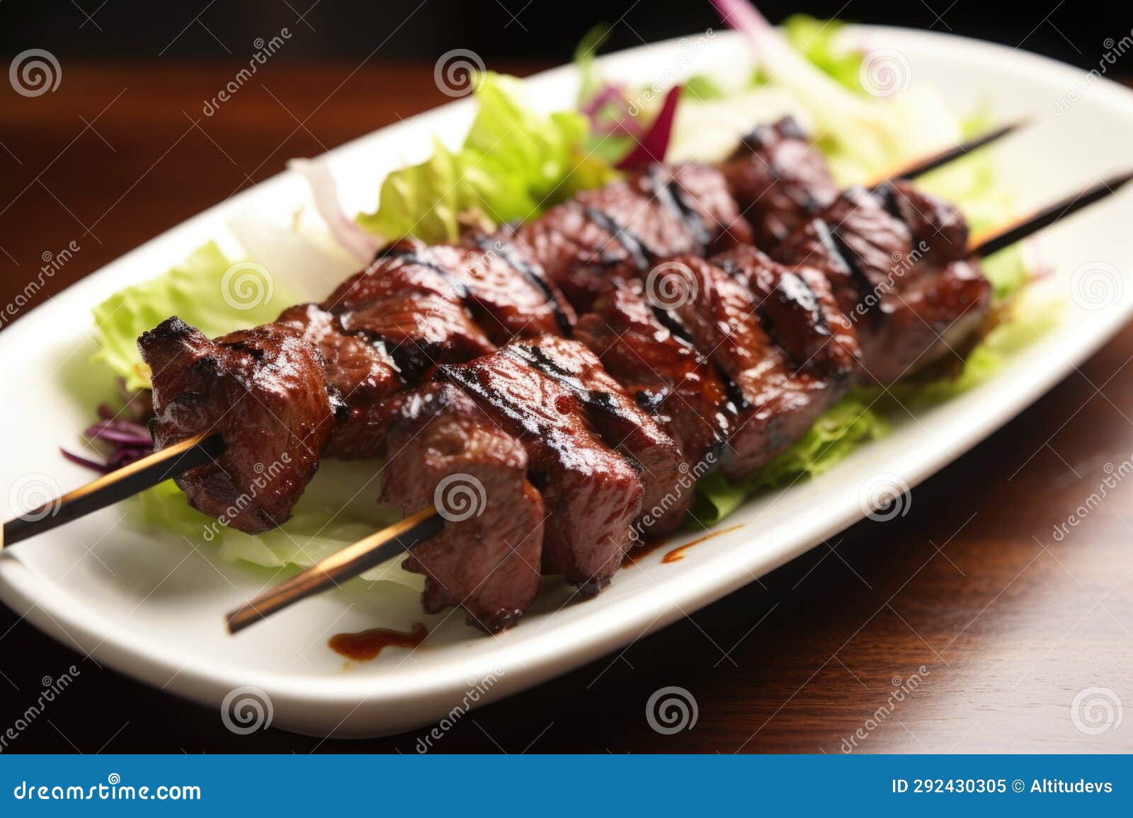 A Trio of Beef Skewers on a Bed of Mixed Lettuce Stock Image - Image of ...