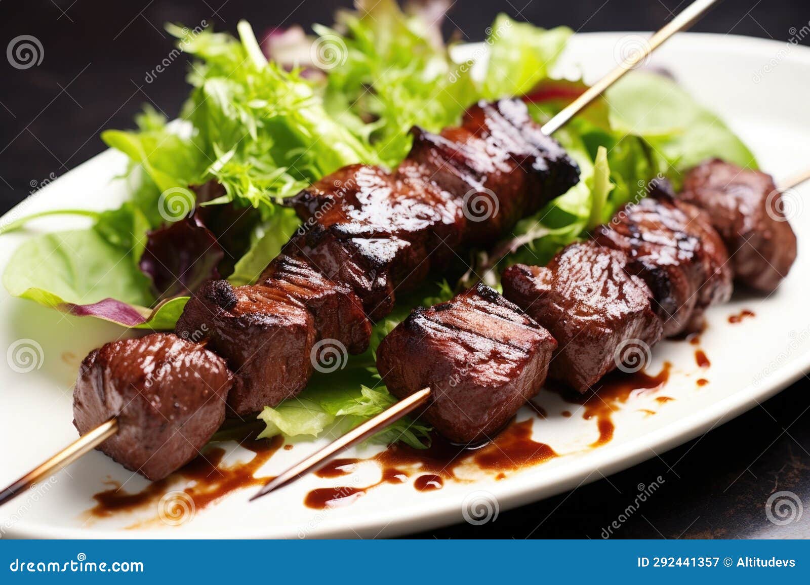 A Trio of Beef Skewers on a Bed of Mixed Lettuce Stock Image - Image of ...