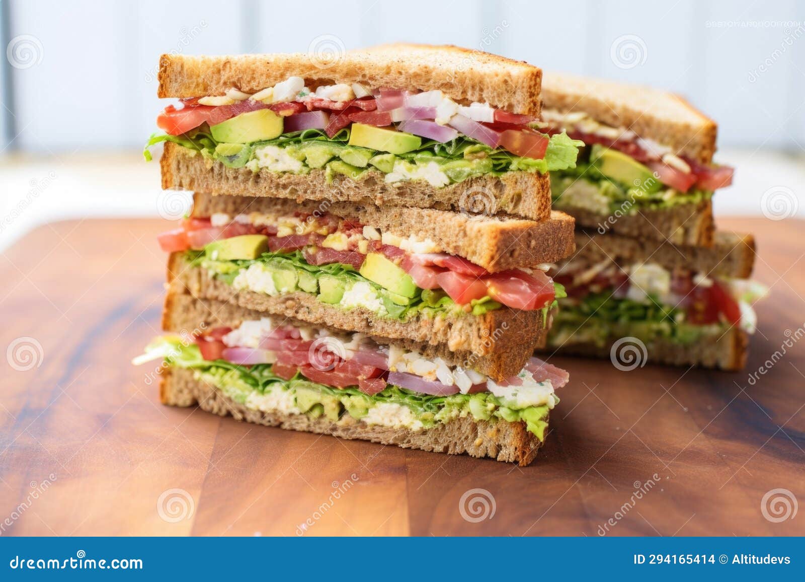 A Triple Decker Sandwich Cut Diagonally on a Chopping Board Stock Photo ...
