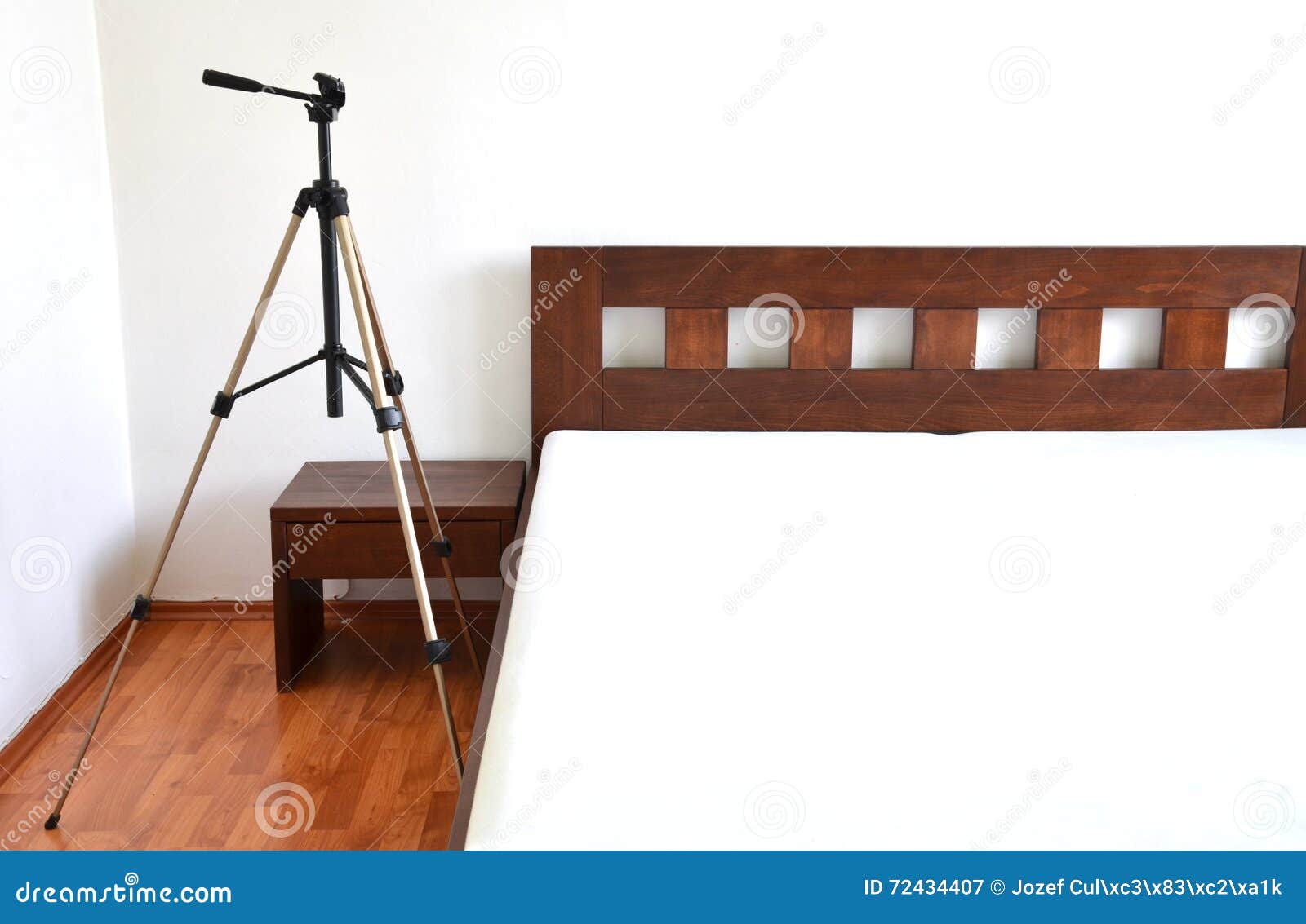 Tripod for Camera Next To the Wooden Bed in Bedroom Stock Image - Image ...