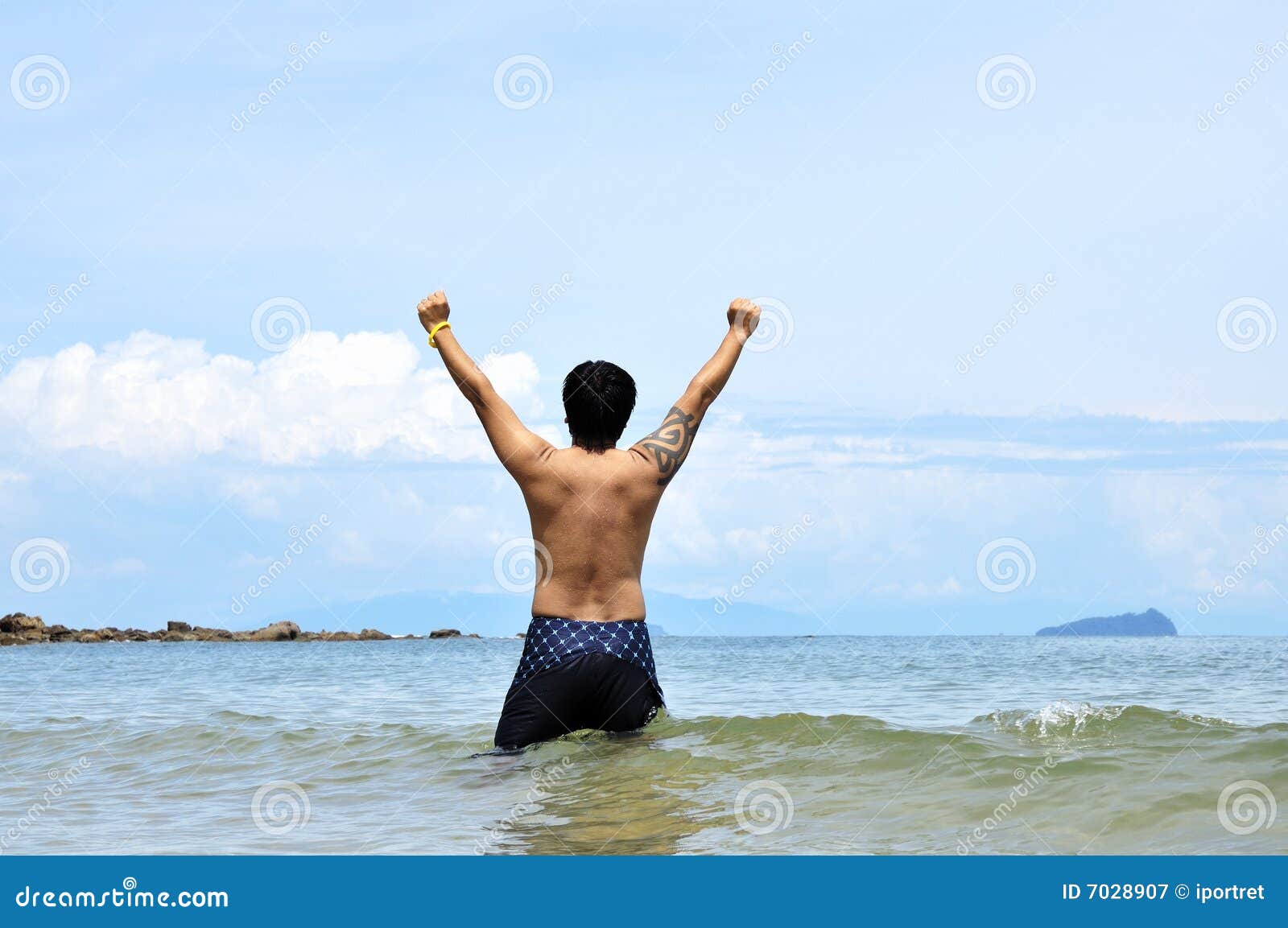 Man Facing Sea with Arms Raised Stock Image - Image of shirtless ...