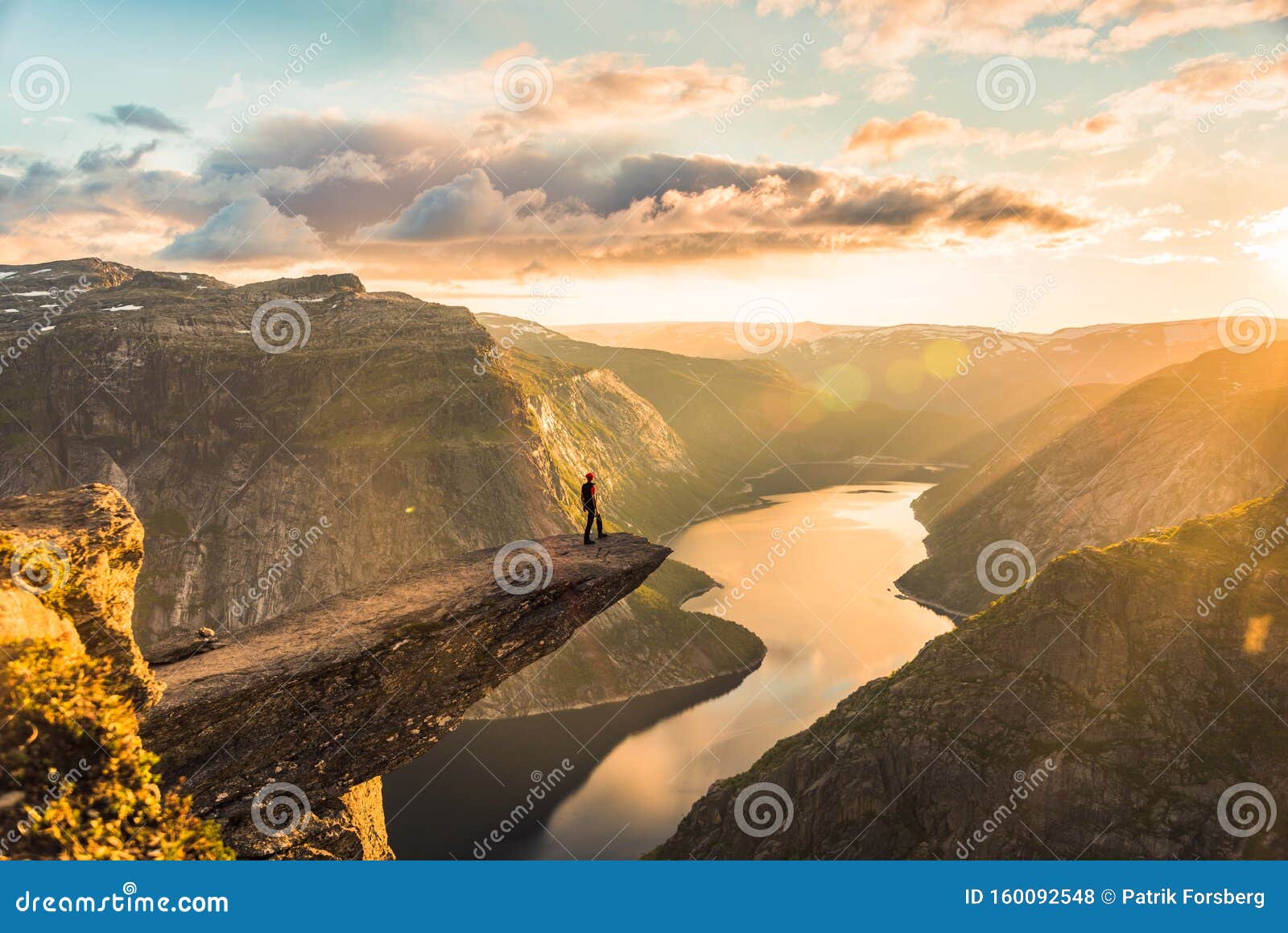Man Facing the Sun on Trolltunga Editorial Stock Photo - Image of ...